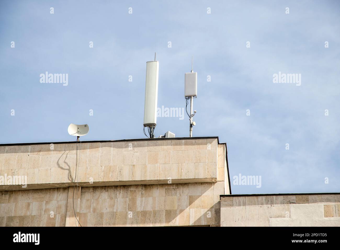 GSM cell phone antenna tower on rooftop Stock Photo - Alamy