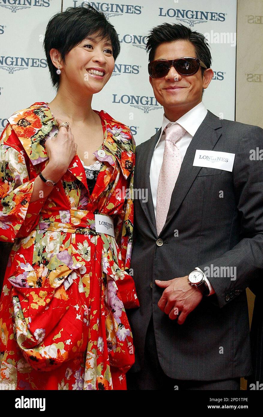 Hong Kong actress Carina Lau, left, and pop singer Aaron Kwok pose for ...