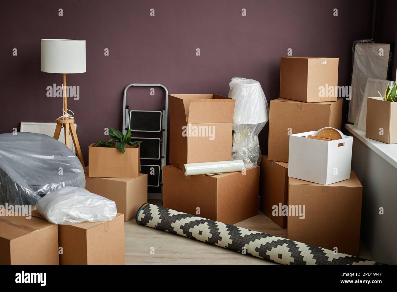 Horizontal image of cardboard boxes with things standing in stack ...