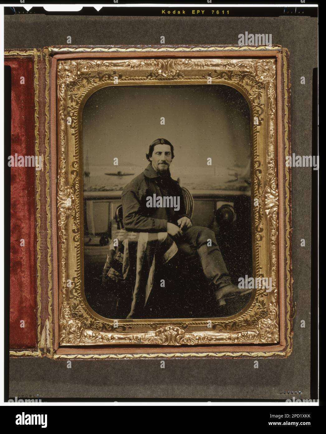 Unidentified sailor seated in front of a painted backdrop showing ...