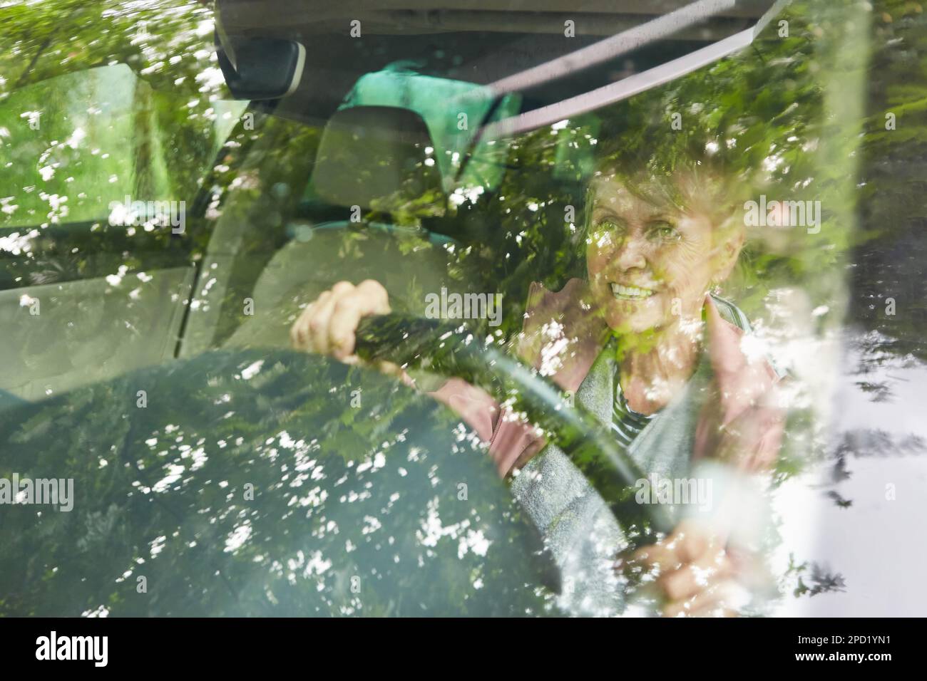 Woman driving seen through windshield of car hi-res stock photography ...