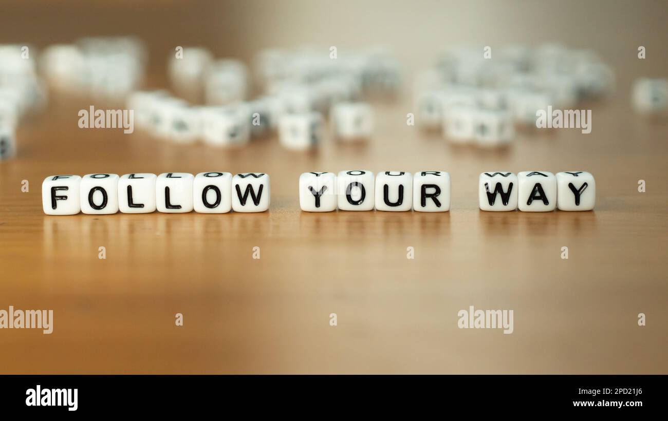 Follow your way slogan in white block letter beads Stock Photo - Alamy