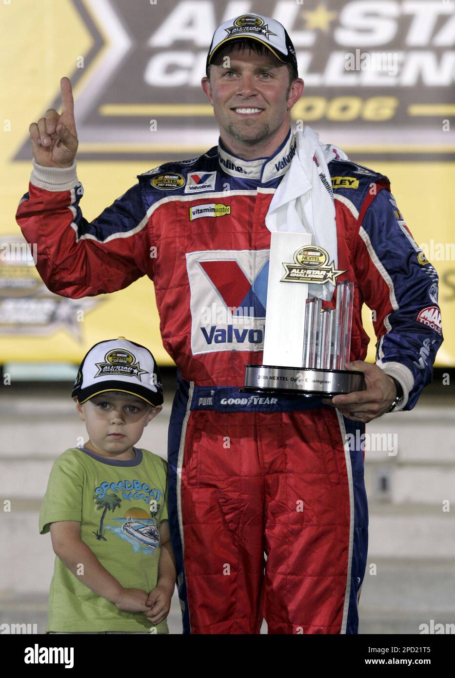 Scott Riggs poses with trophy with his son Layne, 3, in victory lane ...