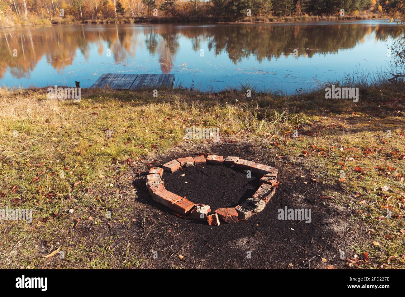 A brick circle for burning a bonfire located by the pond Stock Photo ...