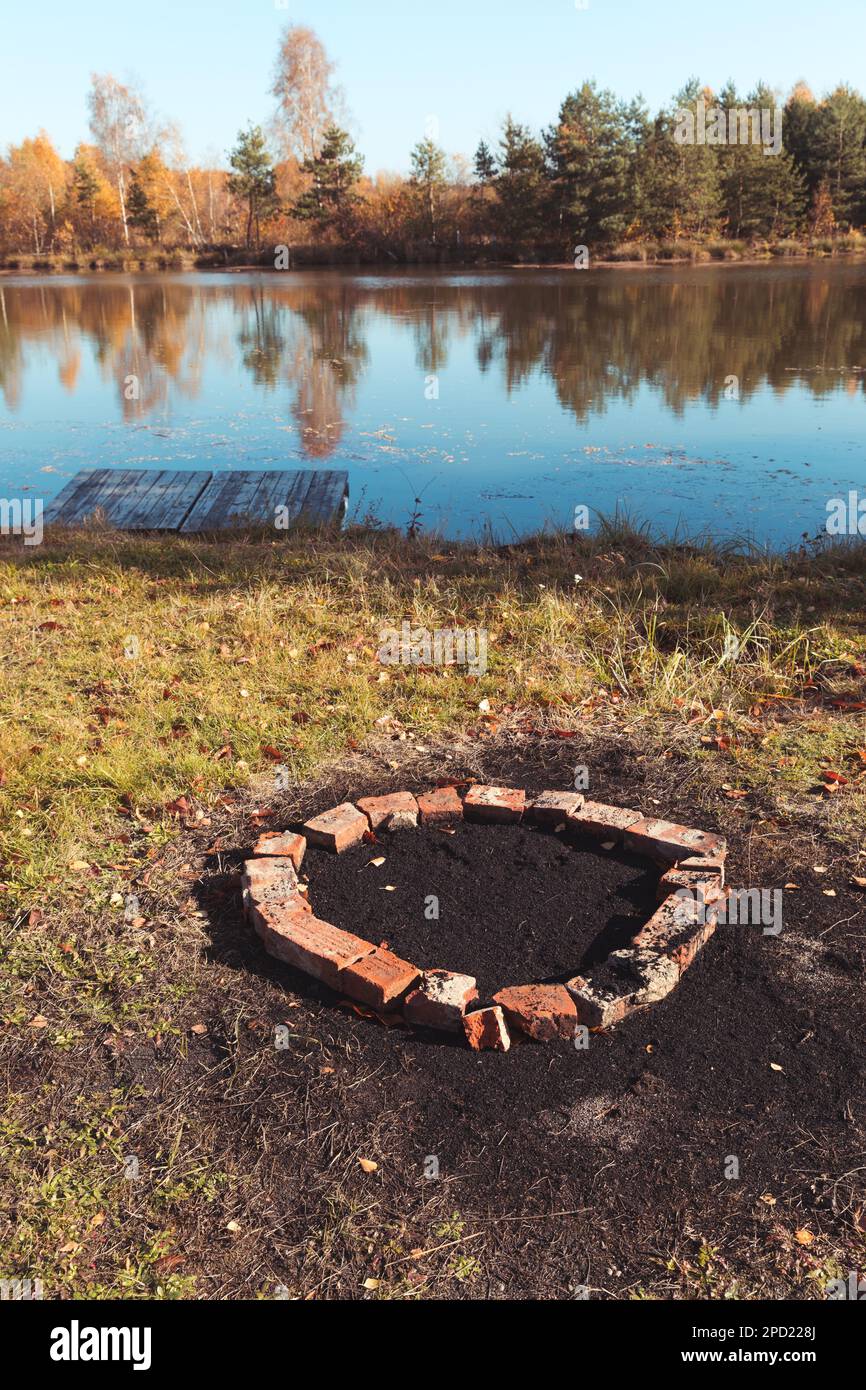 A brick circle for burning a bonfire located by the pond Stock Photo ...
