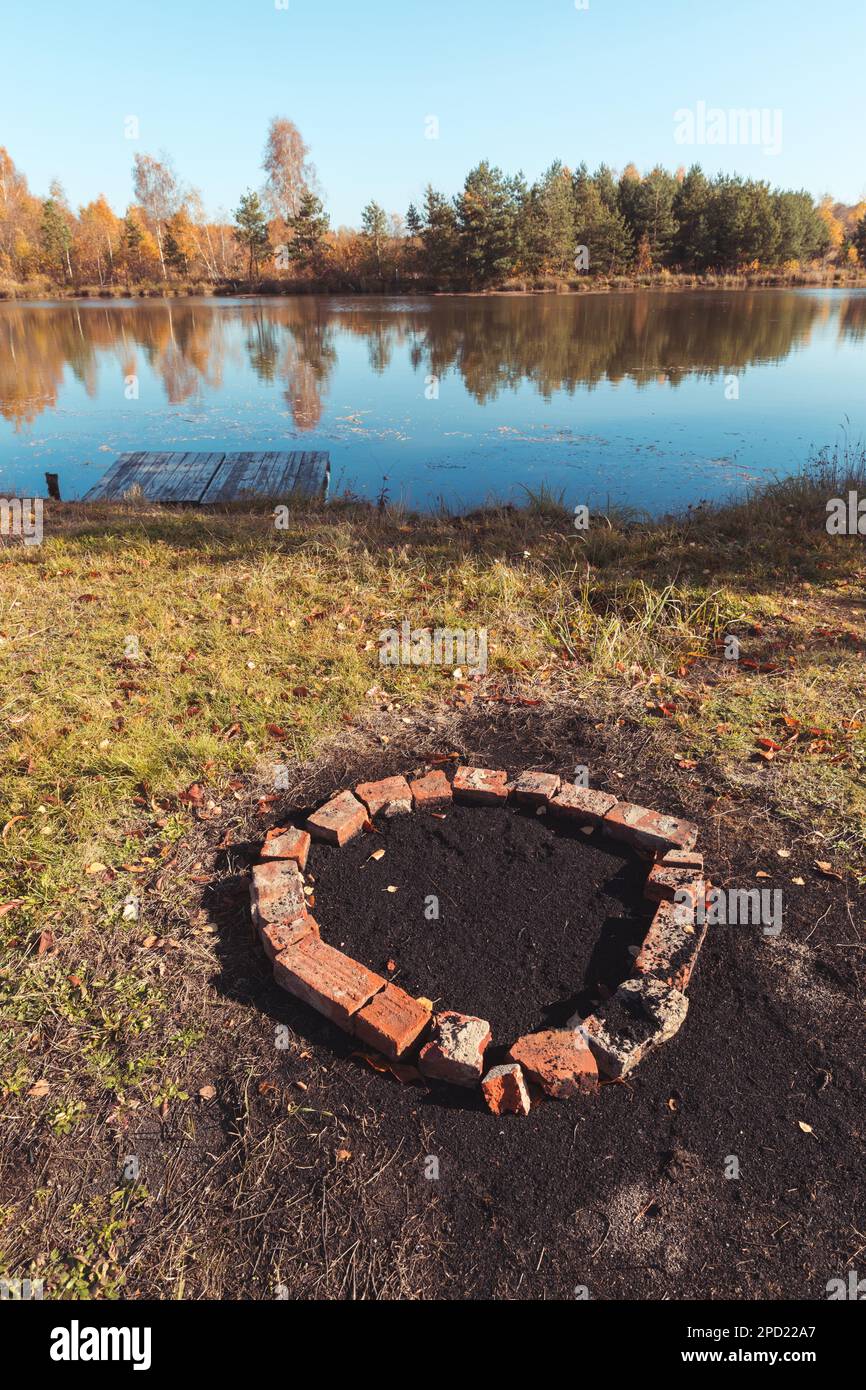 A brick circle for burning a bonfire located by the pond Stock Photo ...