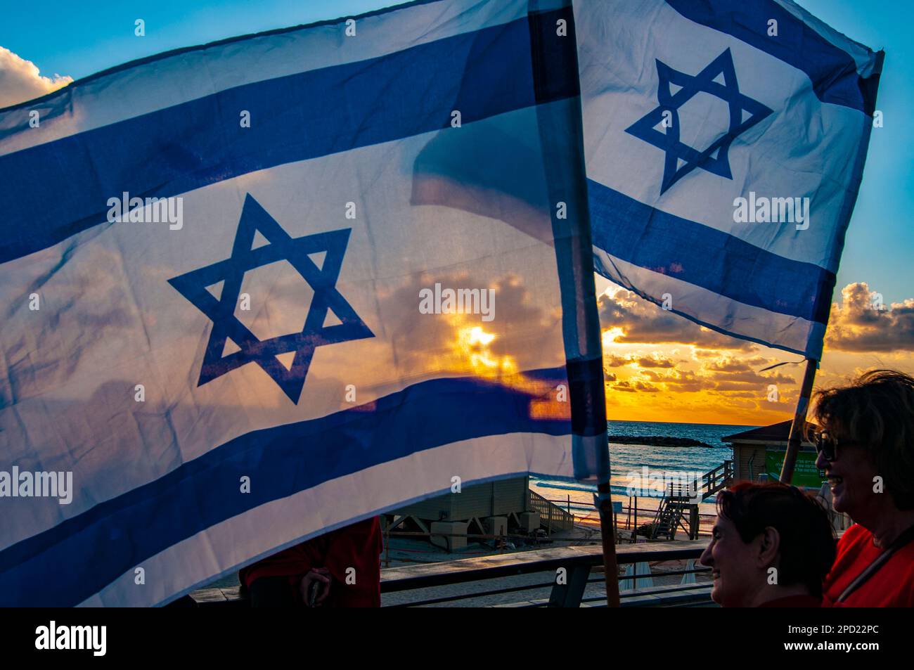 Blue and white Israeli flag waving in the wind with a Mediterranean Sun ...