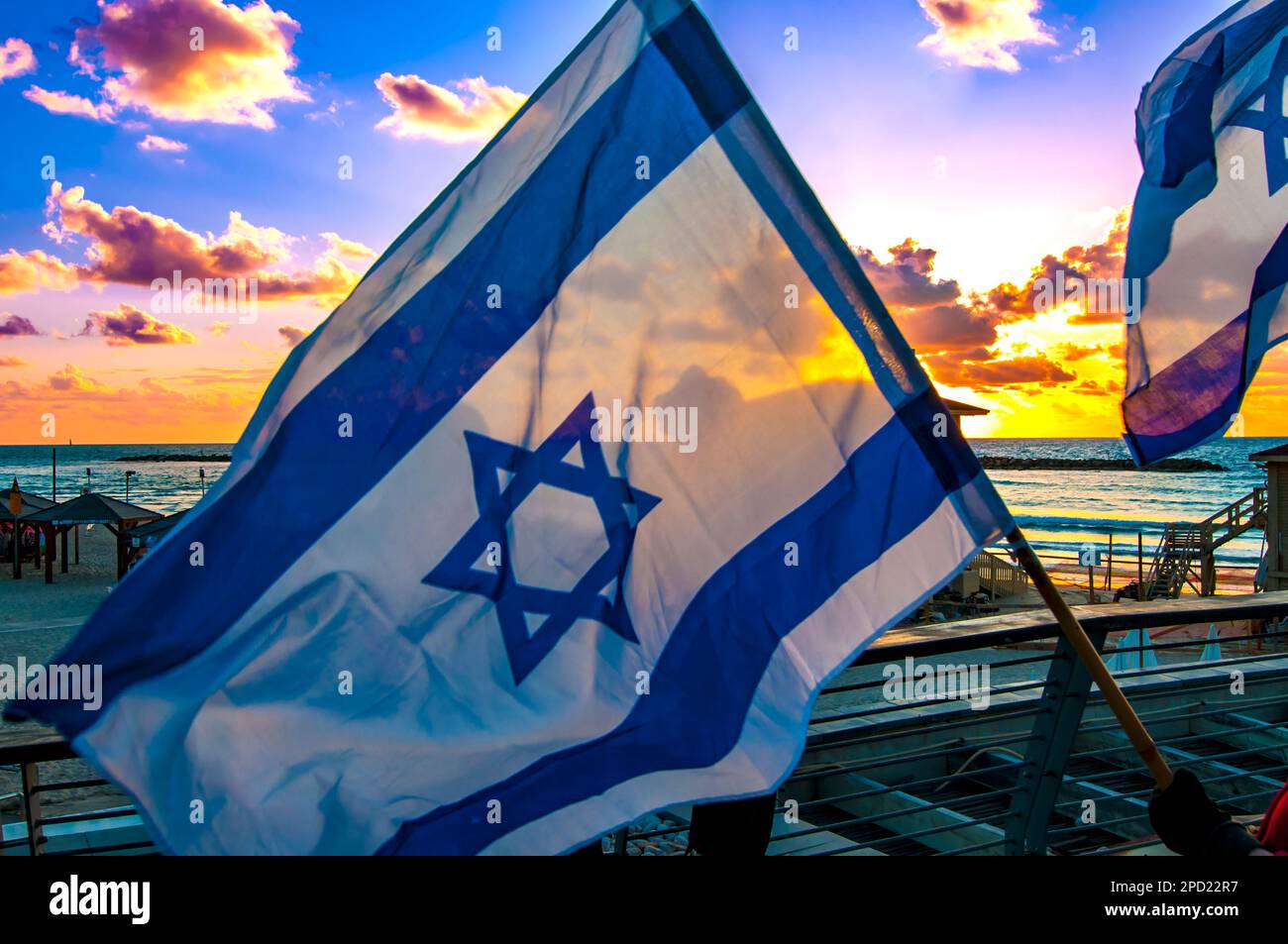 Blue and white Israeli flag waving in the wind with a Mediterranean Sun ...