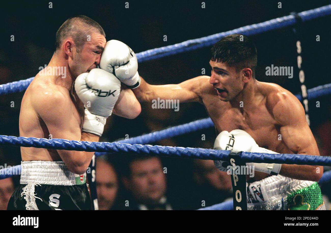 England's boxer Amir Khan, right, lands a right at Laszlo Komjathi of Hungary during the World ...