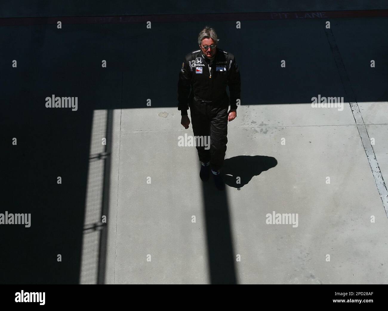 Indy Racing League driver Eddie Cheever Jr. walks from the garages to ...