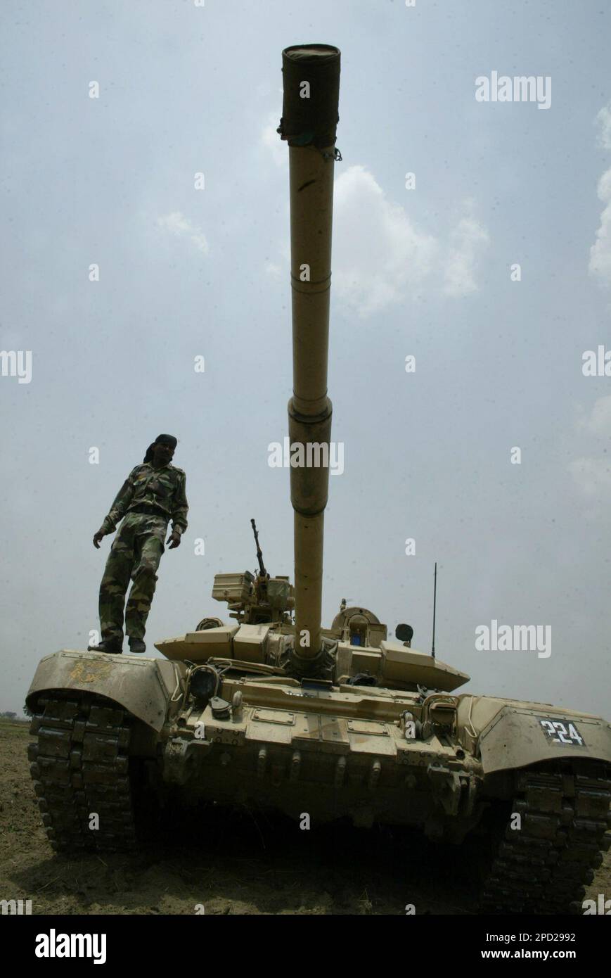 An Indian Army soldier stands on a T-90 tank during a military exercise ...