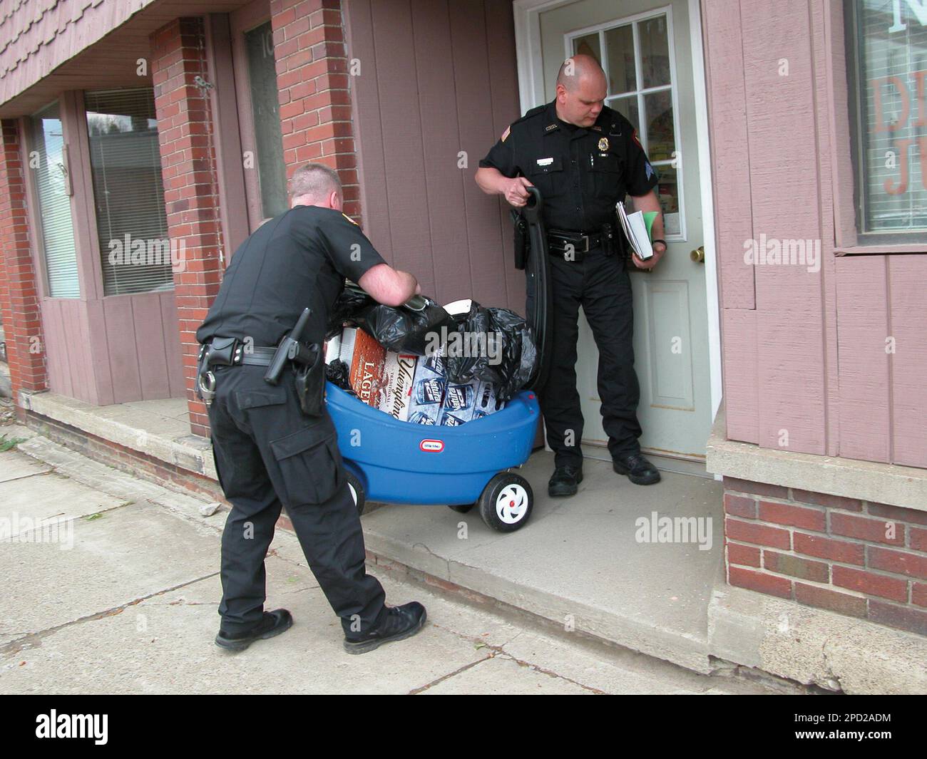Corry City Police Patrolman Jason Chamberlin, left, helps Sgt. Kevin ...