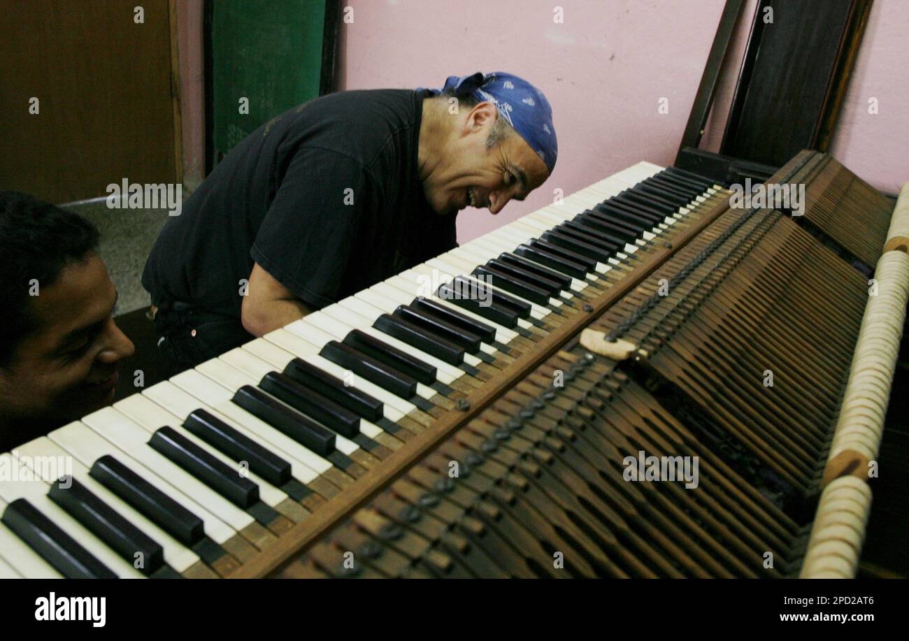 American piano tuner Benjamin Treuhaft, right, smiles as he checks a ...
