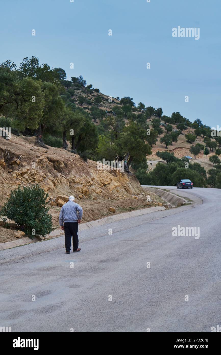 Old man walking on mountain Stock Photo - Alamy