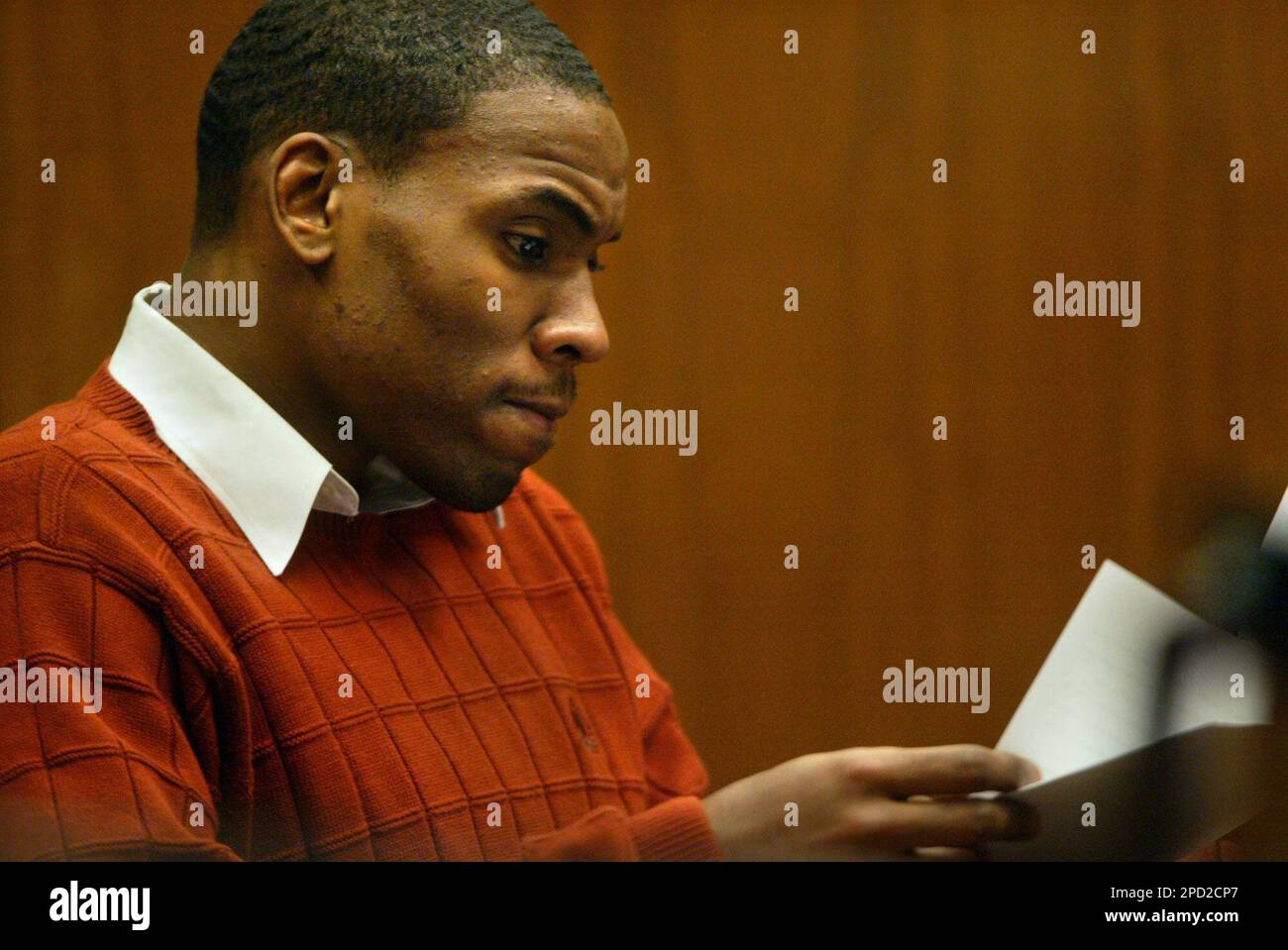 Former Fresno State basketball player Terry Pettis looks over paperwork ...