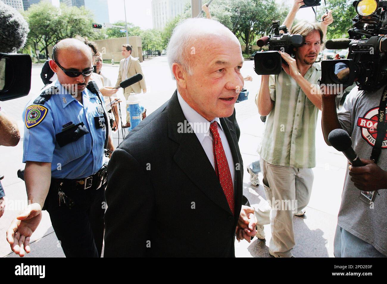 Enron founder Kenneth Lay, center, leaves for the day from the federal ...