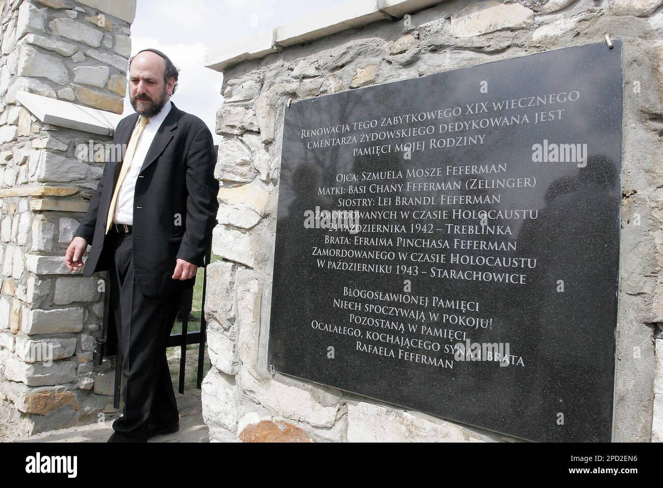 Poland's chief rabbi Michael Schudrich stands by a plate commemorating ...