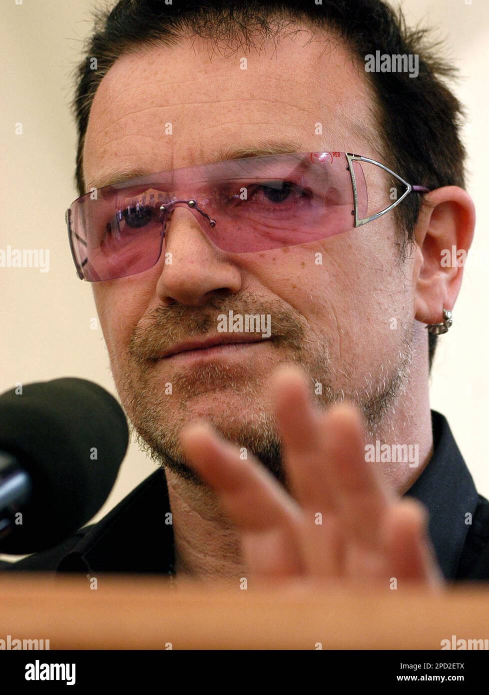 Irish rock star Bono gestures during a media briefing at the Treatment ...