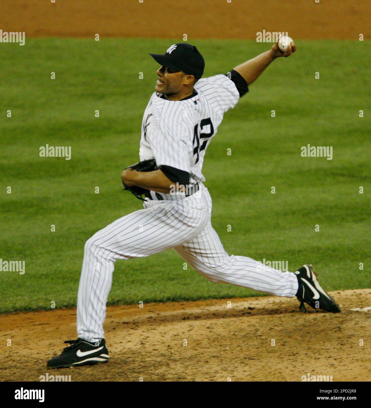 New York Yankees pitcher Mariano Rivera winds up for a pitch in the ...