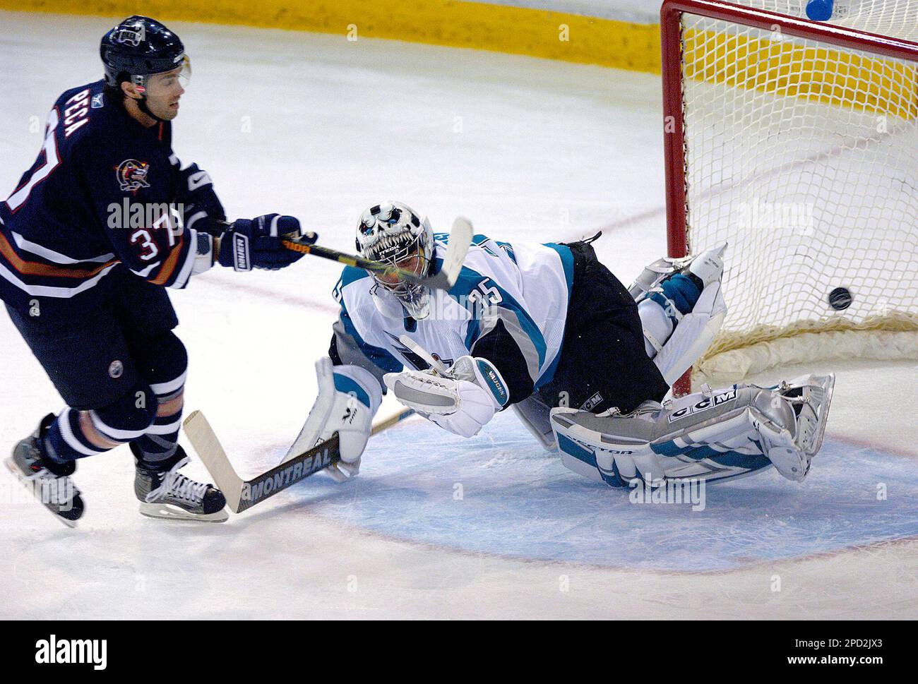 Edmonton Oilers' Michael Peca scores a goal past San Jose Sharks goalie ...
