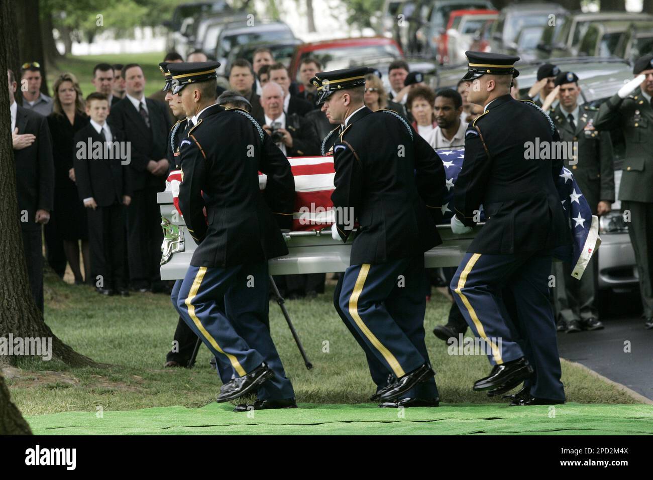 A military honor guard carries the casket of Army Staff Sergeant David ...