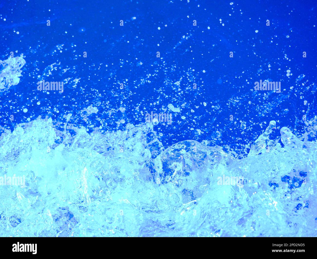 Water bubbling and frothing against deep blue background Stock Photo ...