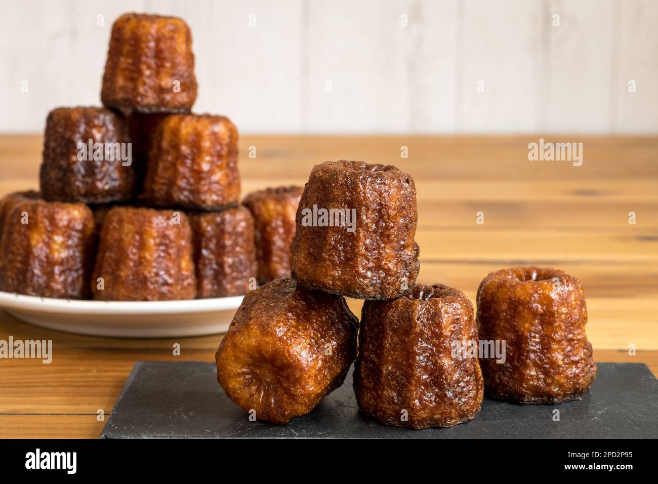 Cannelé, also written Canelé, is a small cylinder-shaped cake ...