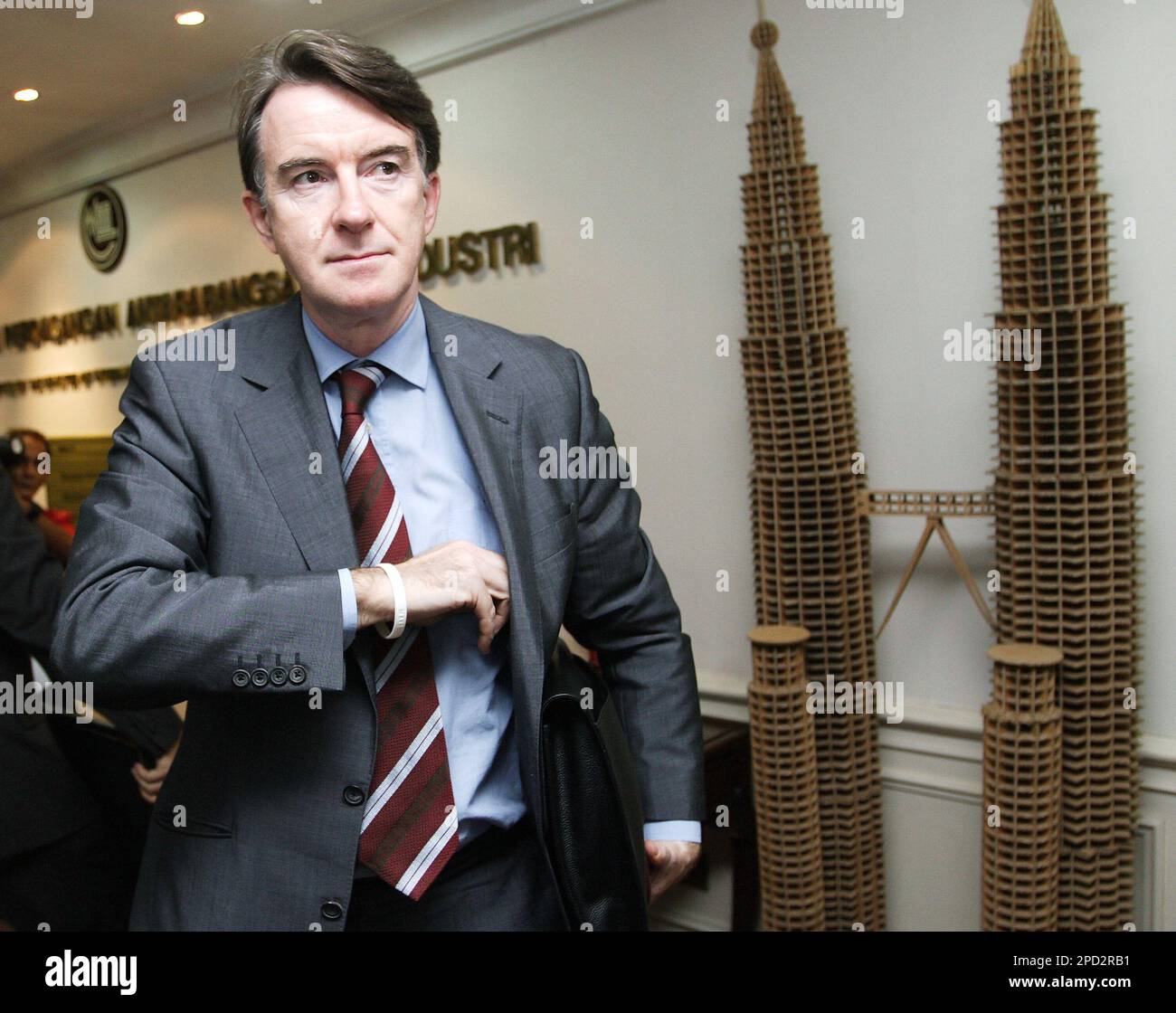 European Union trade chief Peter Mandelson walks past a replica of ...