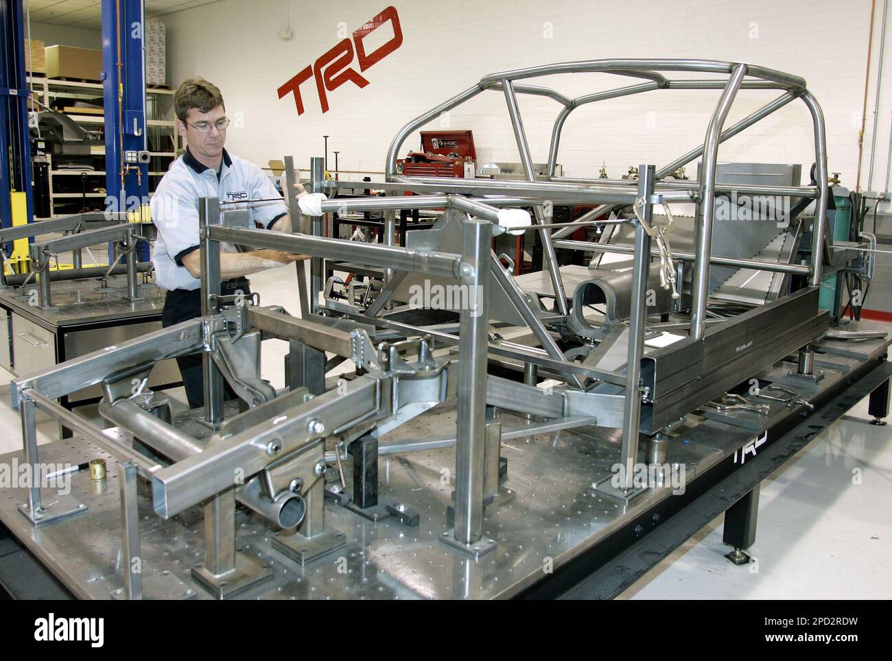 Gene Watson works on a Car of Tomorrow chassis for a Toyota Camry ...