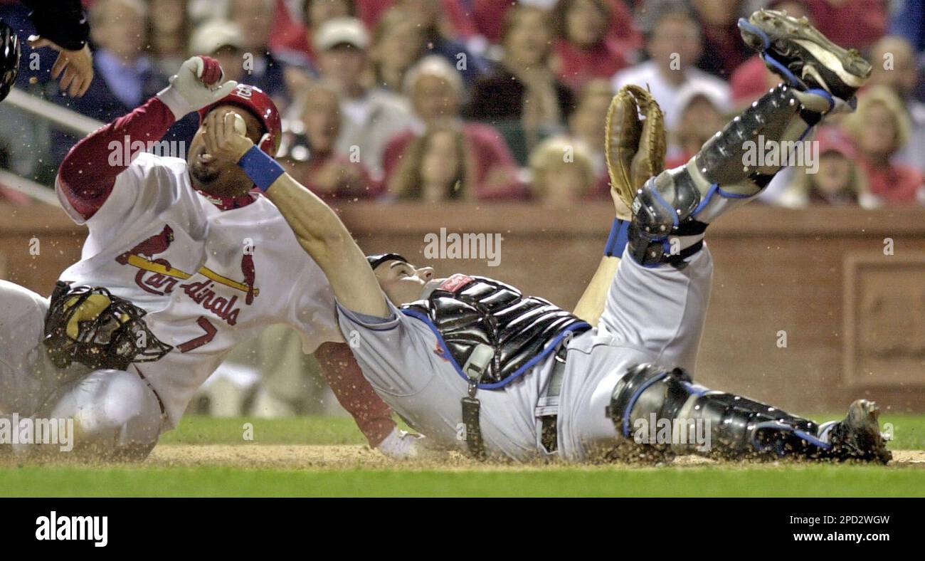 St. Louis Cardinals Hector Luna (7) is safe at the plate as he avoids ...