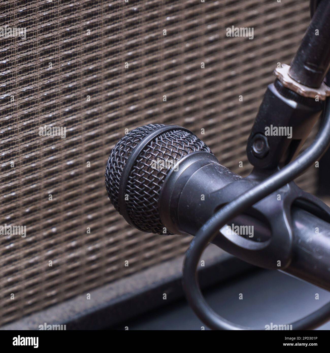 Instrumental microphone in front of the speaker of the guitar combo ...