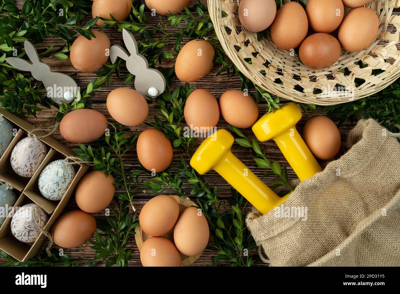 Gym dumbbells, Easter eggs, boxwood branches and bunny decorations ...