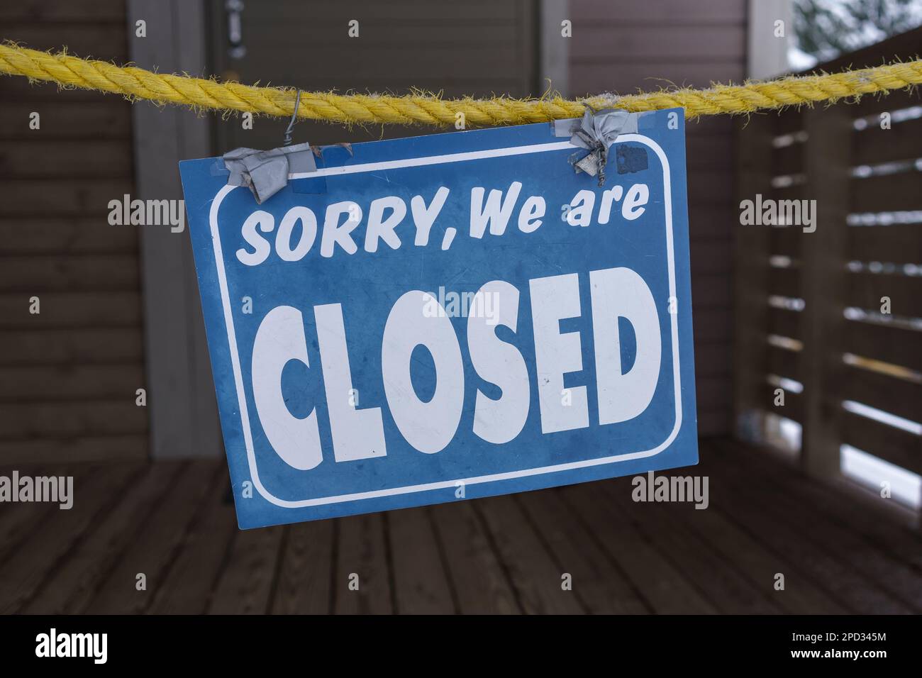 Sorry we are closed sign hanging on rope, close up Stock Photo - Alamy