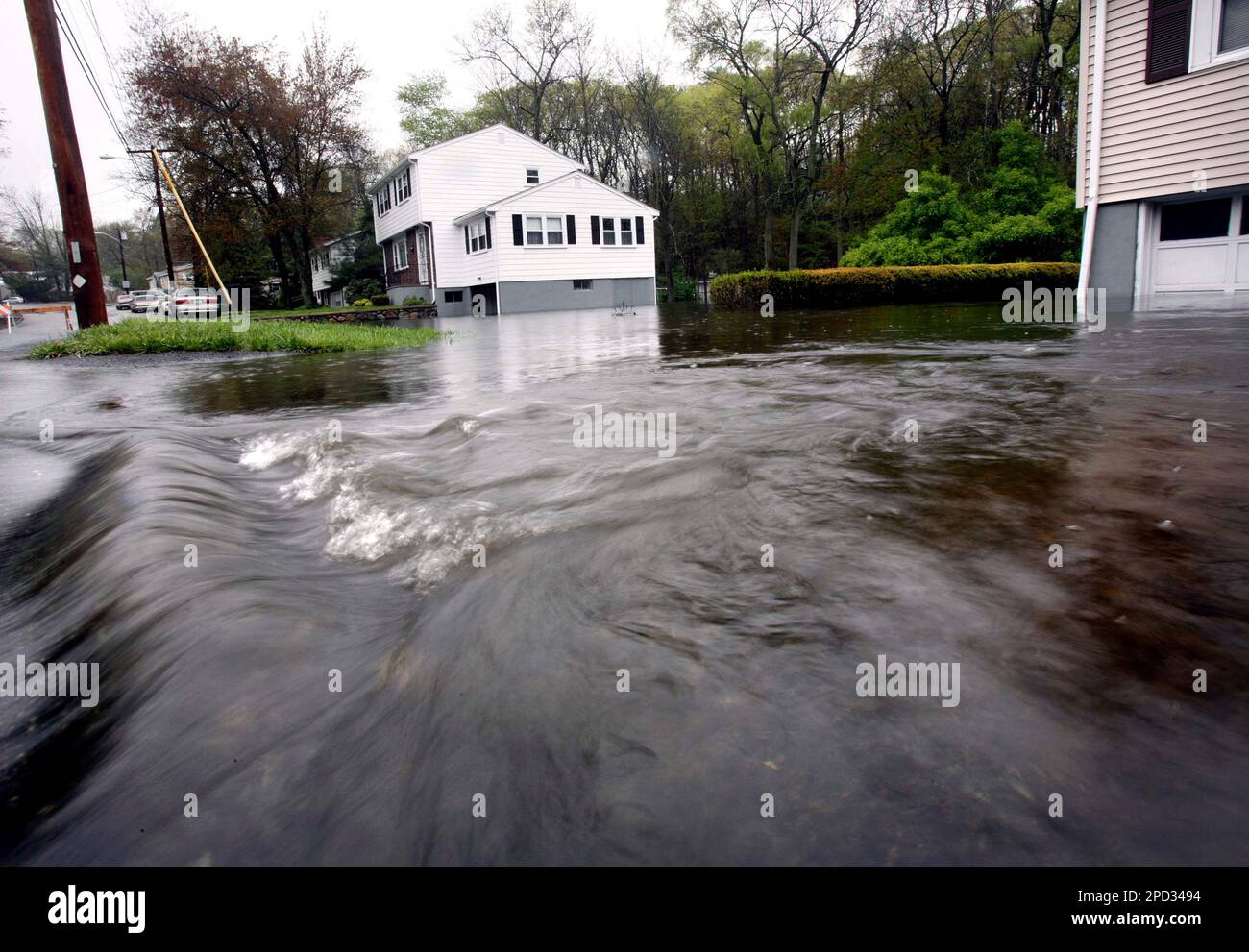 Water from the Saugus river floods a residential neighborhood in Saugus ...