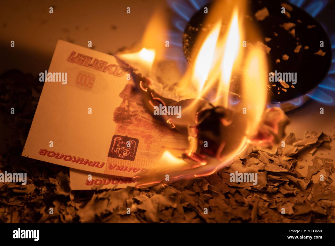 Burning rubles banknotes. High natural gas bills. Different ...
