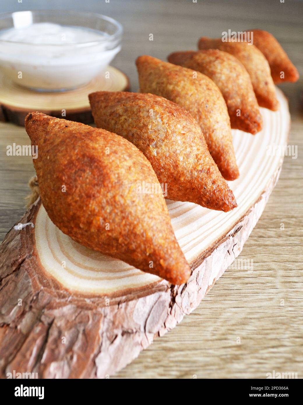 Famous Arabic Kubbeh stuffed meat balls presented on a woody base with ...