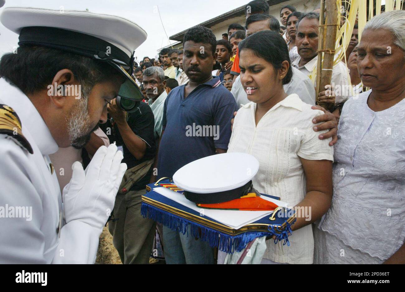 Shamali Liyanage, second right, accepts the medals and flags of her ...