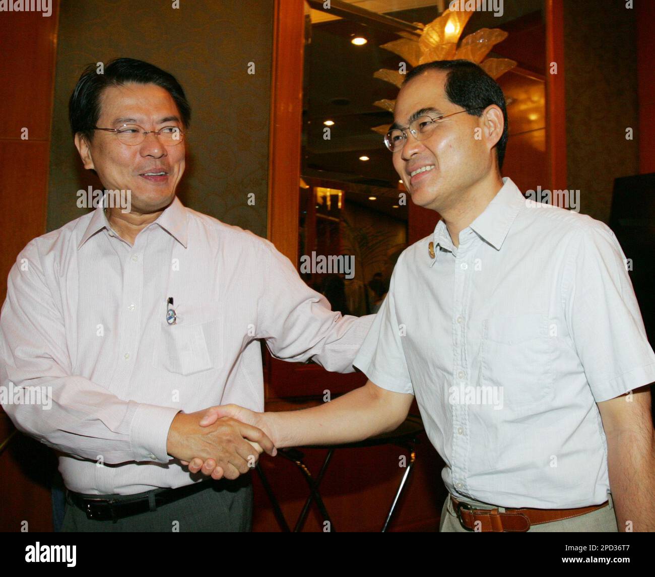 Philippine Trade Secretary Peter Favila, left, greets Singaporean Trade ...