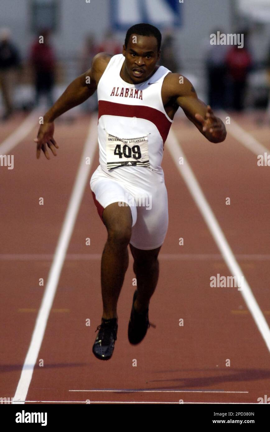 Alabama's Chauncey Harris leans forward as he crosses the finish line ...