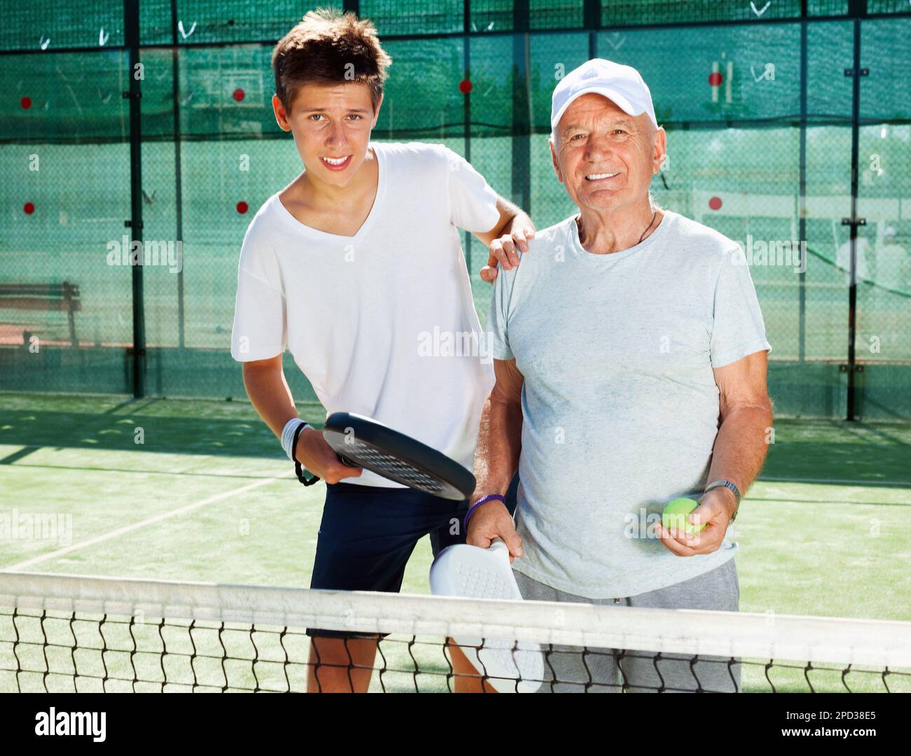 padel players of different generations posing on padel court Stock ...
