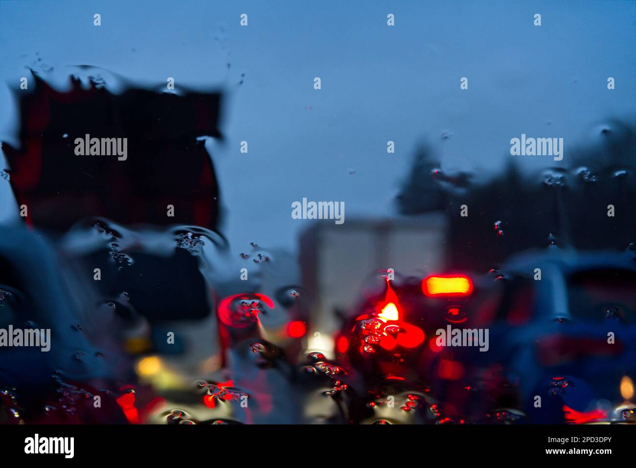 Abstract image of static traffic on a UK motorway in very wet and rainy ...