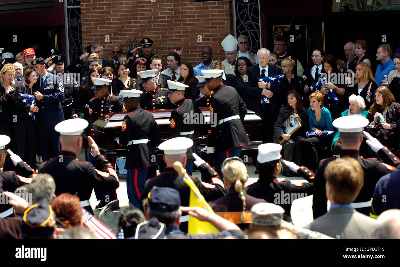 U.S. Marine Corps pallbearers carry the flag-draped casket of Marine ...
