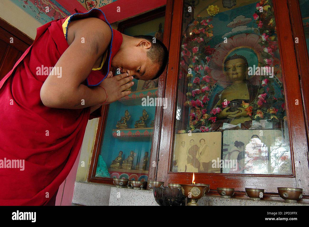 A monk prays at a monastery in Amingaon, about 30 kilometers (19 miles ...