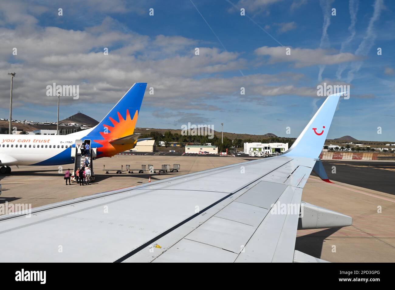 A wing of a Boeing 737 TUI chartered airplane taken in flight showing ...