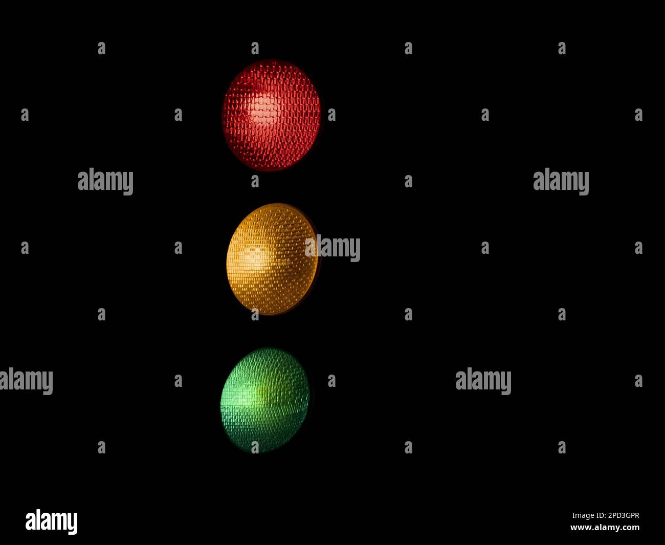 A traffic light red yellow green isolated on black Stock Photo - Alamy