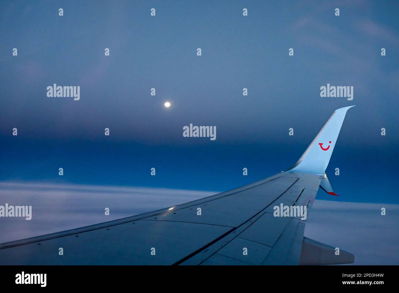 A wing of a Boeing 737 TUI chartered airplane taken in flight showing ...