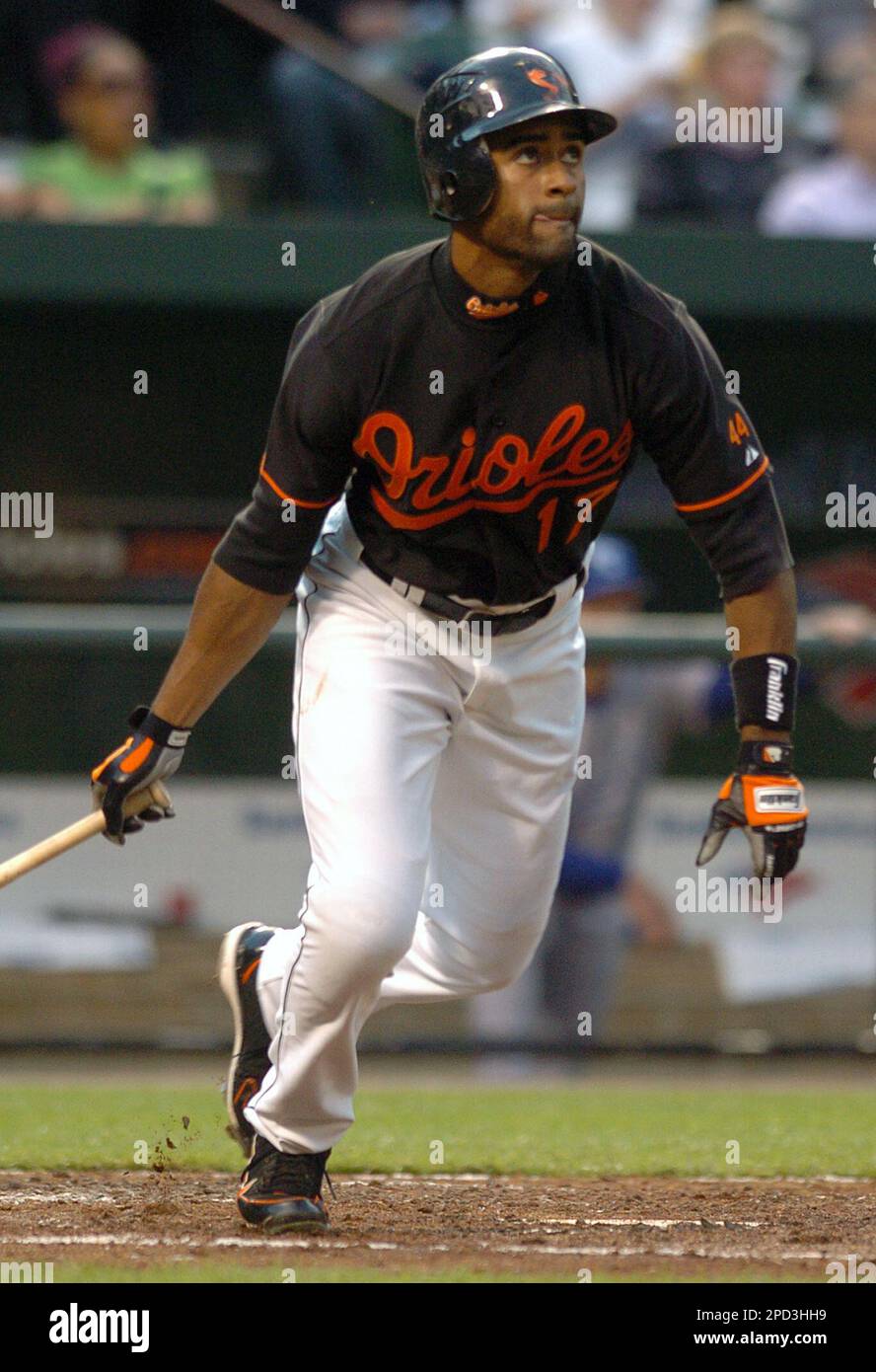 Baltimore Orioles' Corey Patterson follows the flight of his three-run ...
