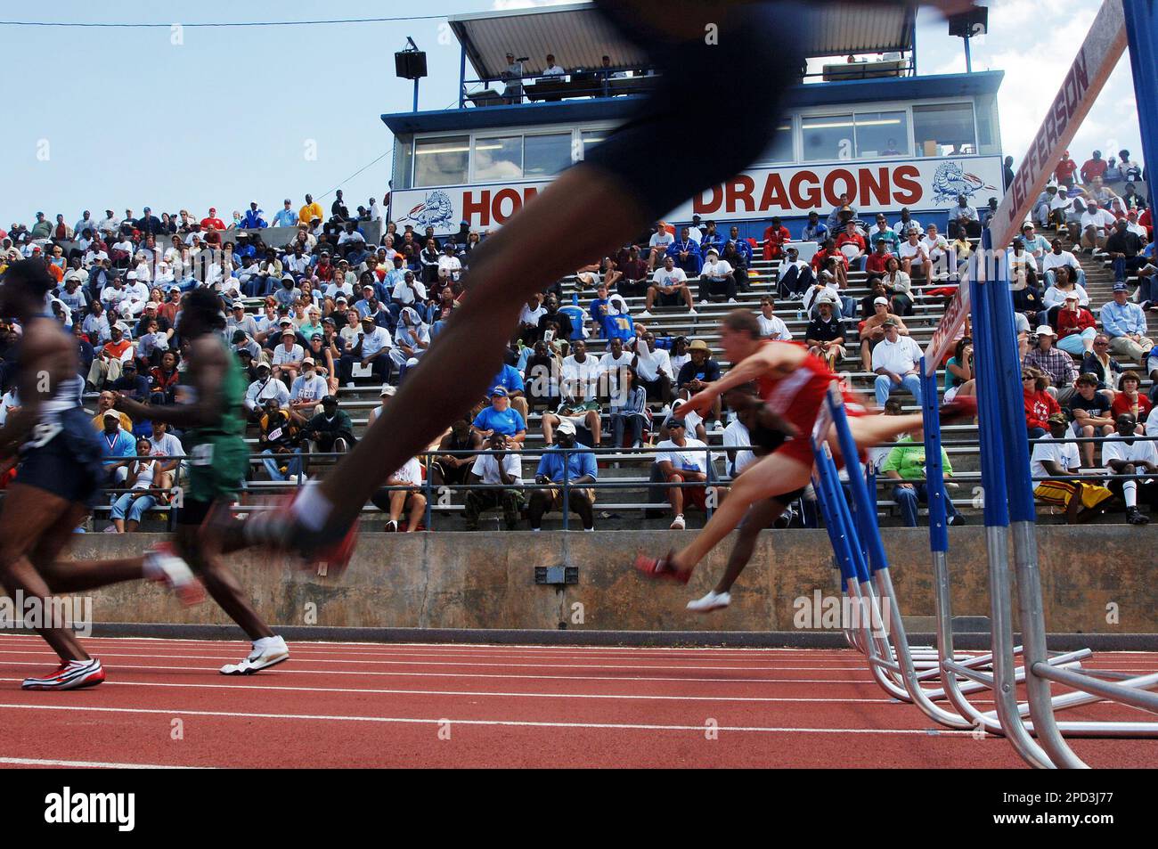 Competitors race in preliminaries of the boys' Class AA 110-meter high ...