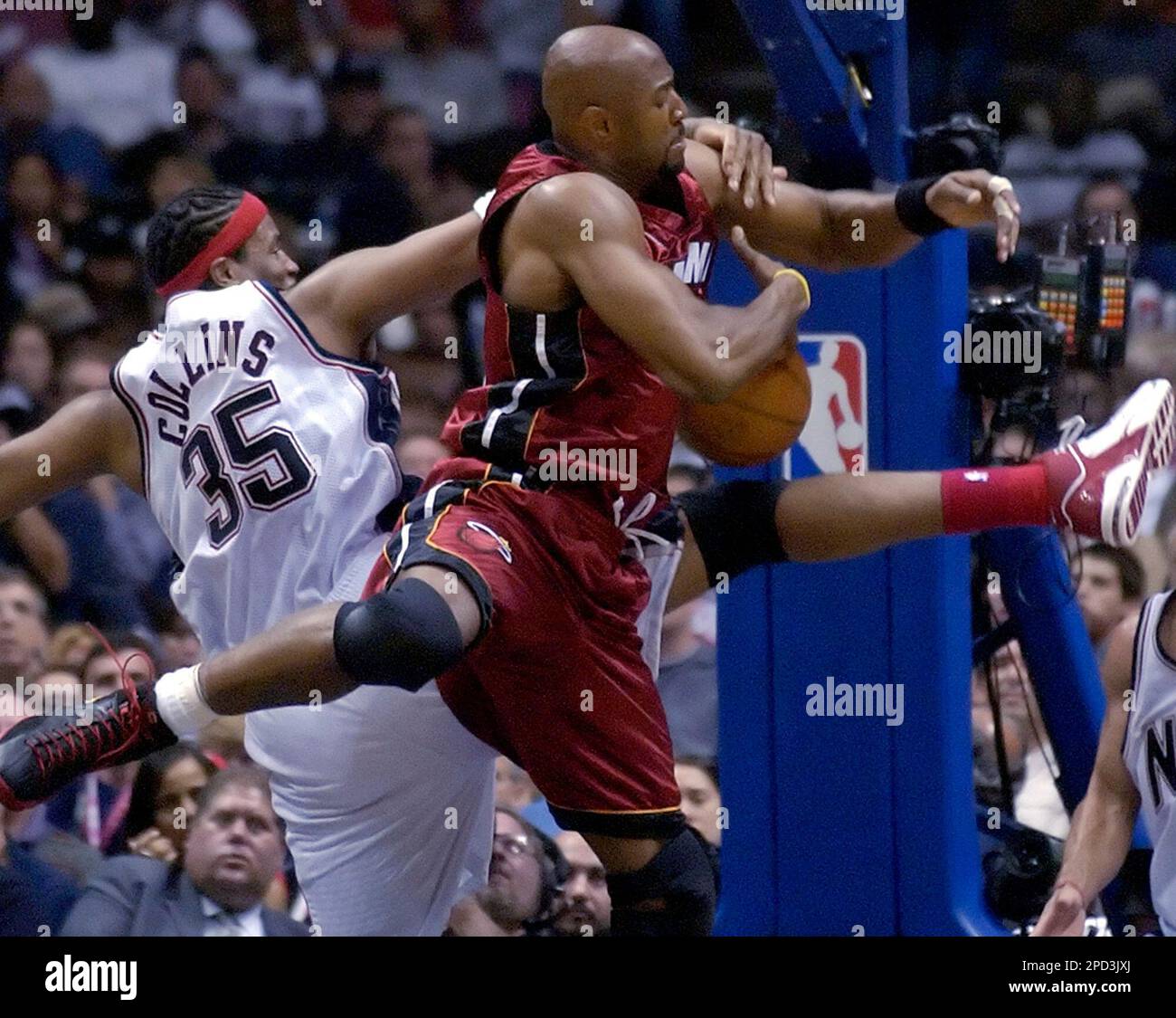 Miami Heat center Alonzo Mourning, right, battles for a rebound with ...