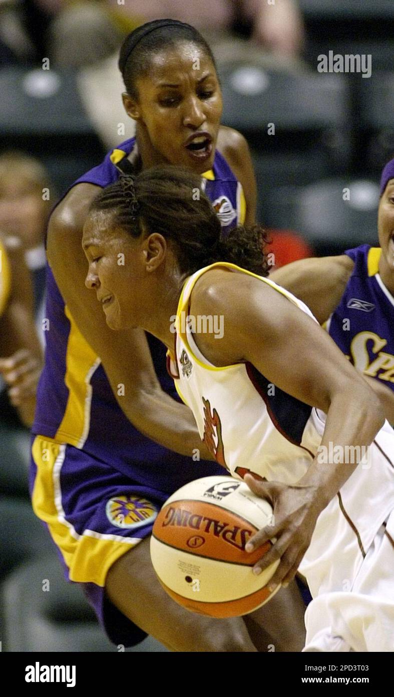 Indiana Fever's Tamika Catchings, front, drives on Los Angeles Sparks ...